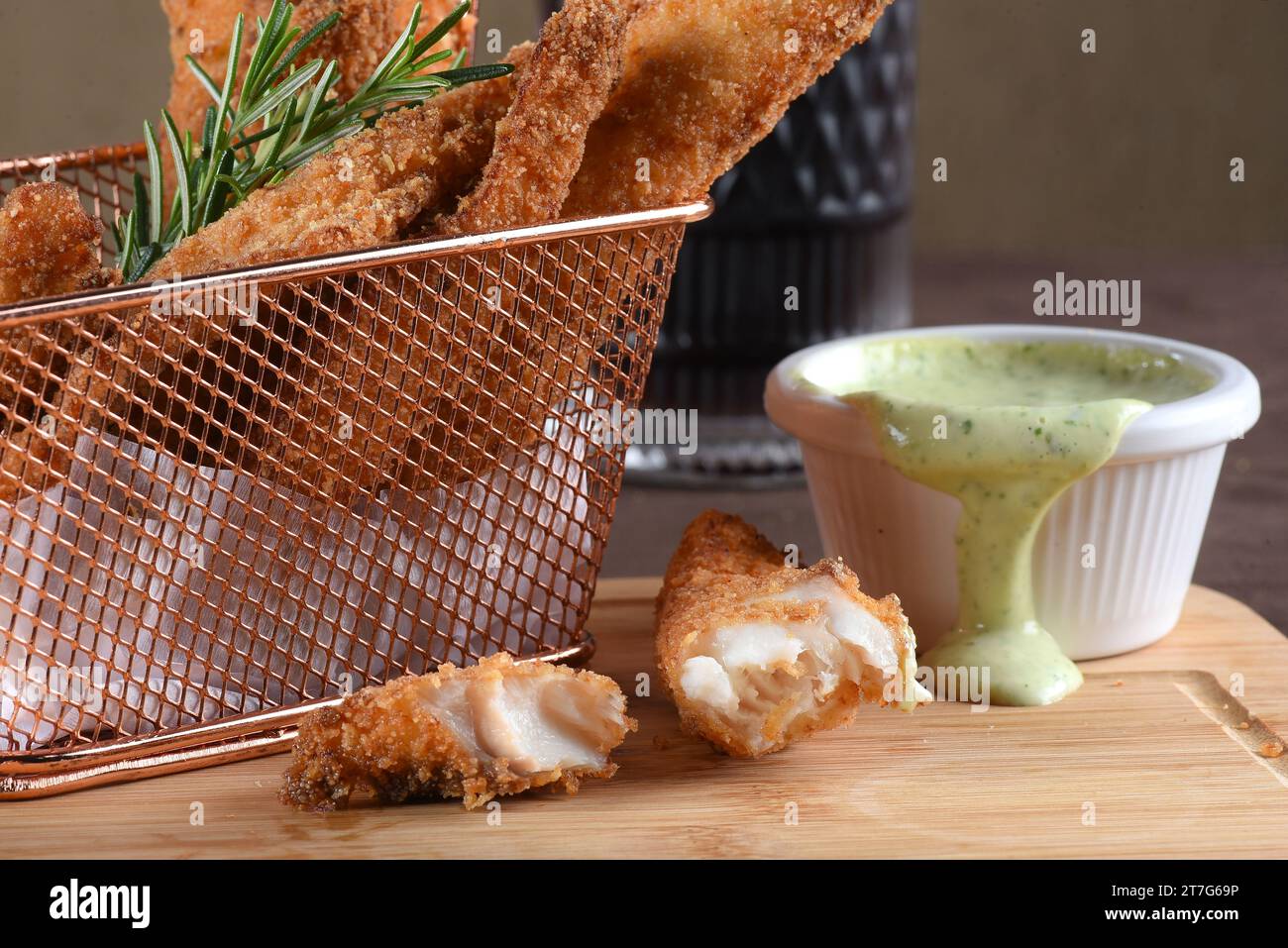 portion of fried fish, fried chicken strips inside metal basket tasty ...