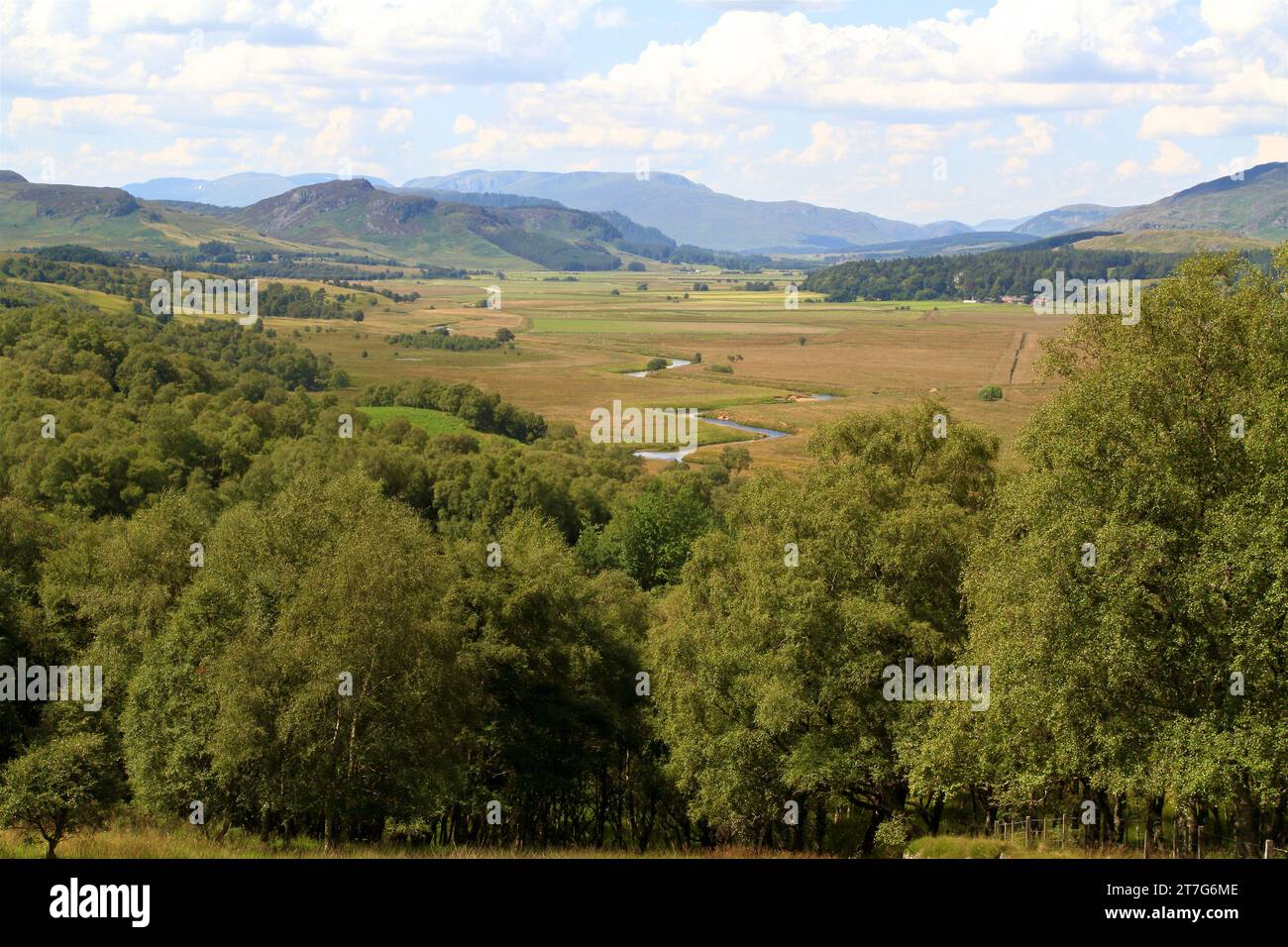 panoramic view of the hills, trees and clouds with a twisting river ...