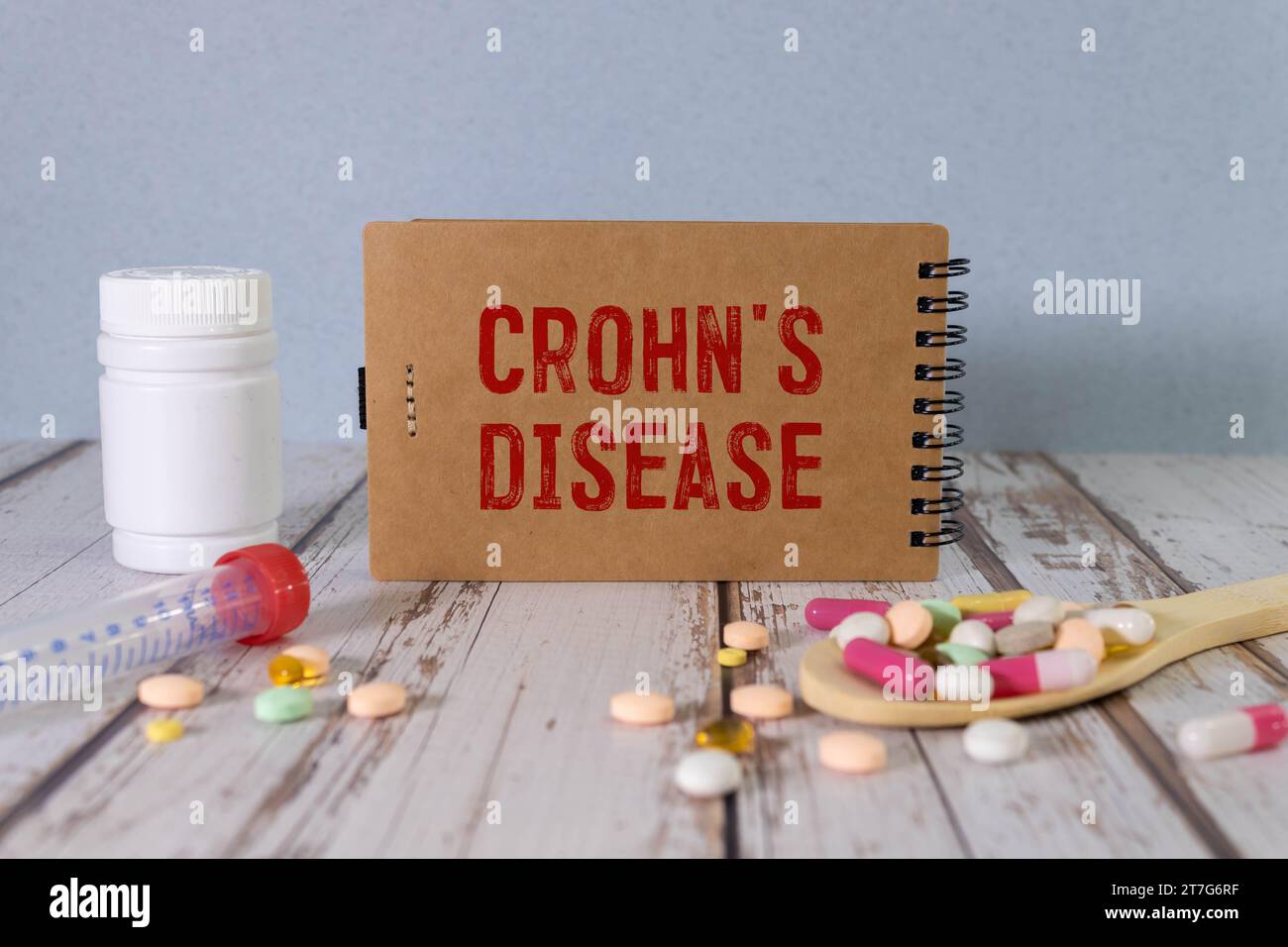 Paper with CROHN'S DISEASE on the office desk, stethoscope and pills ...