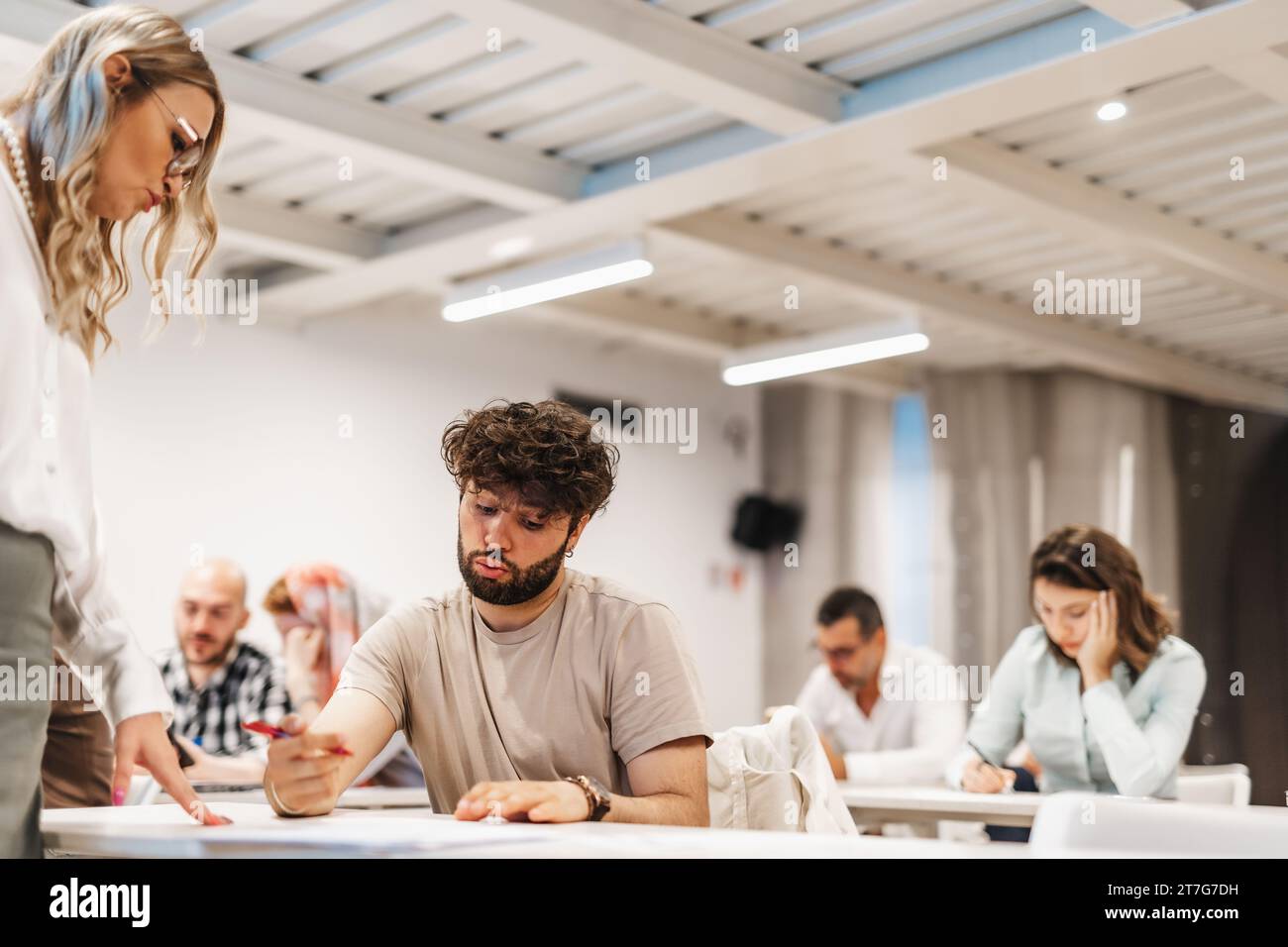 Business people listening intently and engaging in discussion about the ...