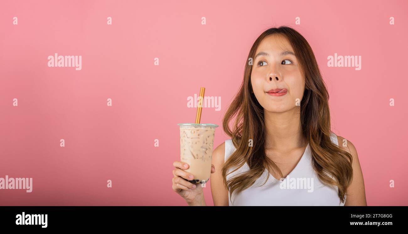 woman holding drinking brown sugar flavored tapioca pearl bubble milk ...