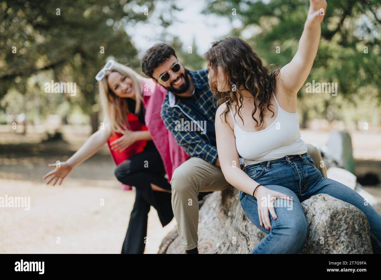 Two cheerful young women hang out in a city park, enjoying nature and ...