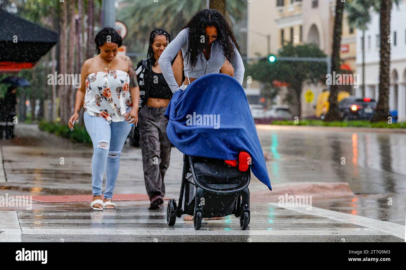 A woman pushing a baby stroller crosses the street along Ponce De Leon ...