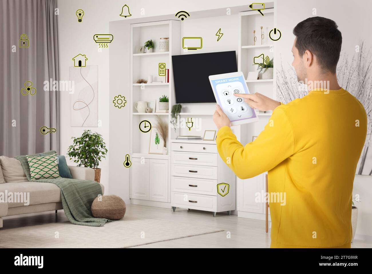 Man Using Smart Home Control System Via Application On Tablet Indoors