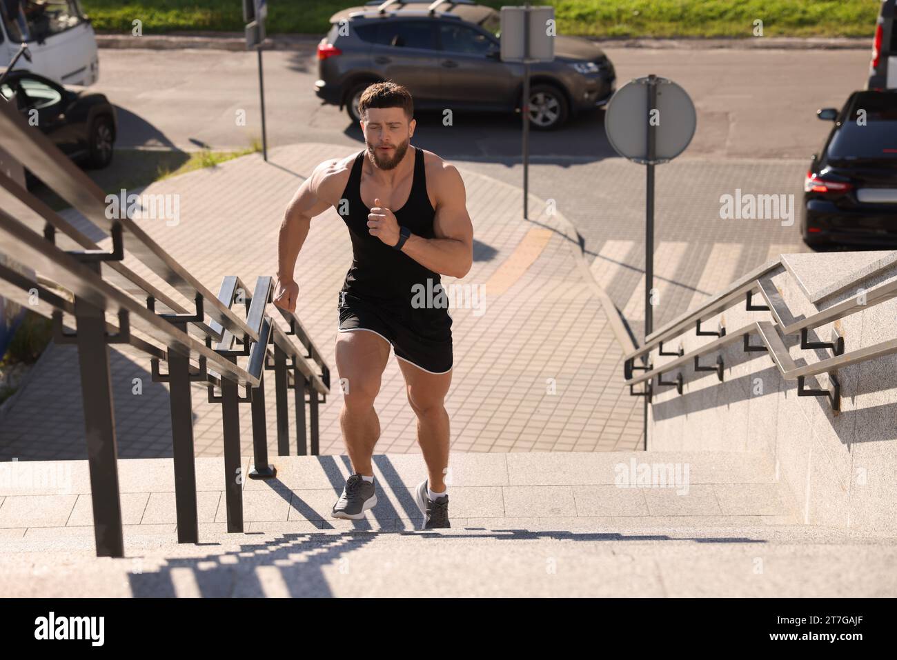 Man running up stairs outdoors on sunny day Stock Photo - Alamy