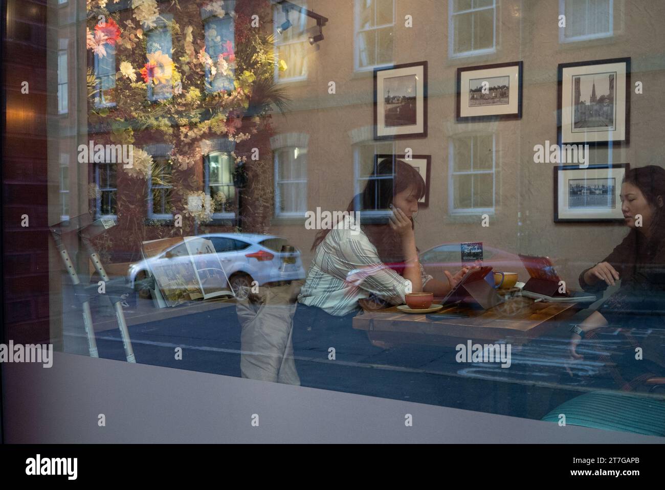 Women in a cafe behind a window, working Stock Photo - Alamy