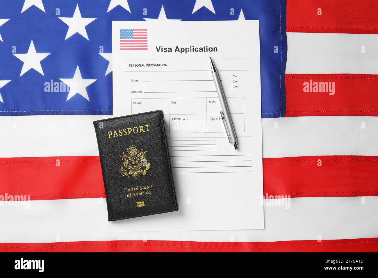 Immigration to USA. Visa application form, pen and passport on flag ...
