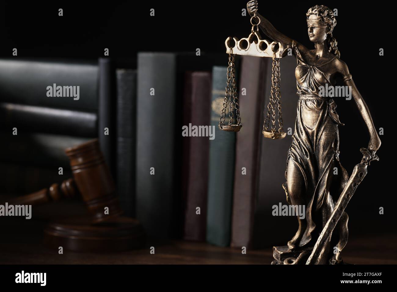 Symbol of fair treatment under law. Statue of Lady Justice near books ...