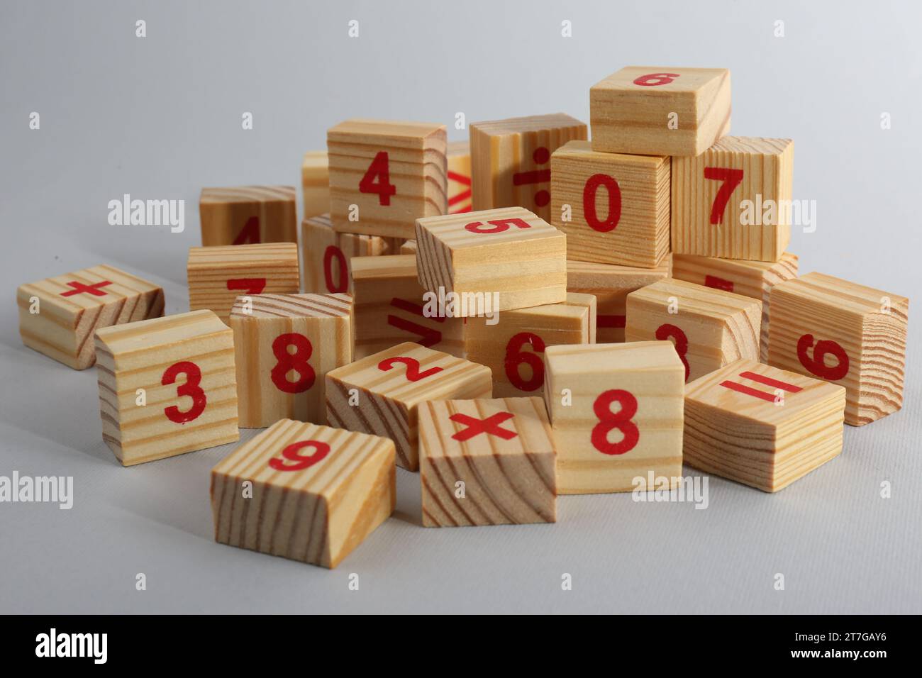Wooden cubes with numbers and mathematical symbols on light background ...