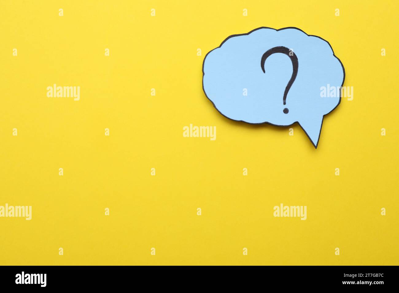 Paper speech bubble with question mark on yellow background, top view ...