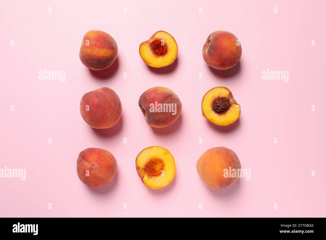 Cut and whole fresh ripe peaches on pink background, flat lay Stock ...