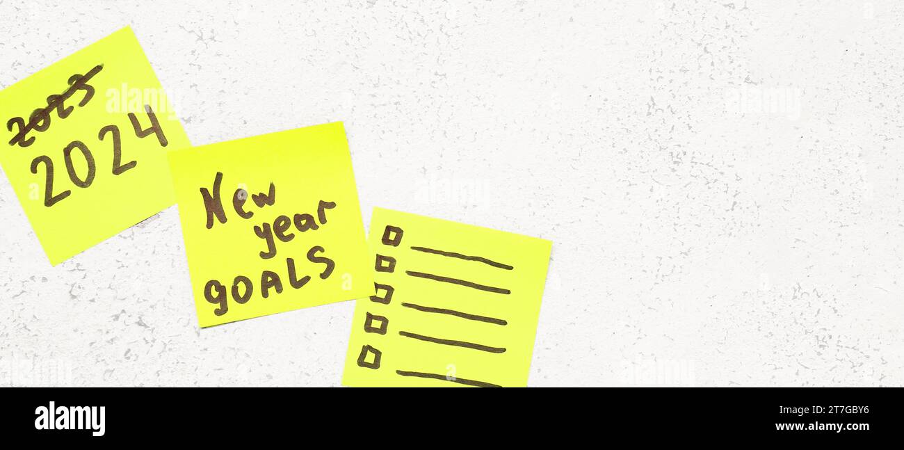 Sticky notes with different goals for 2024 on light grunge background ...