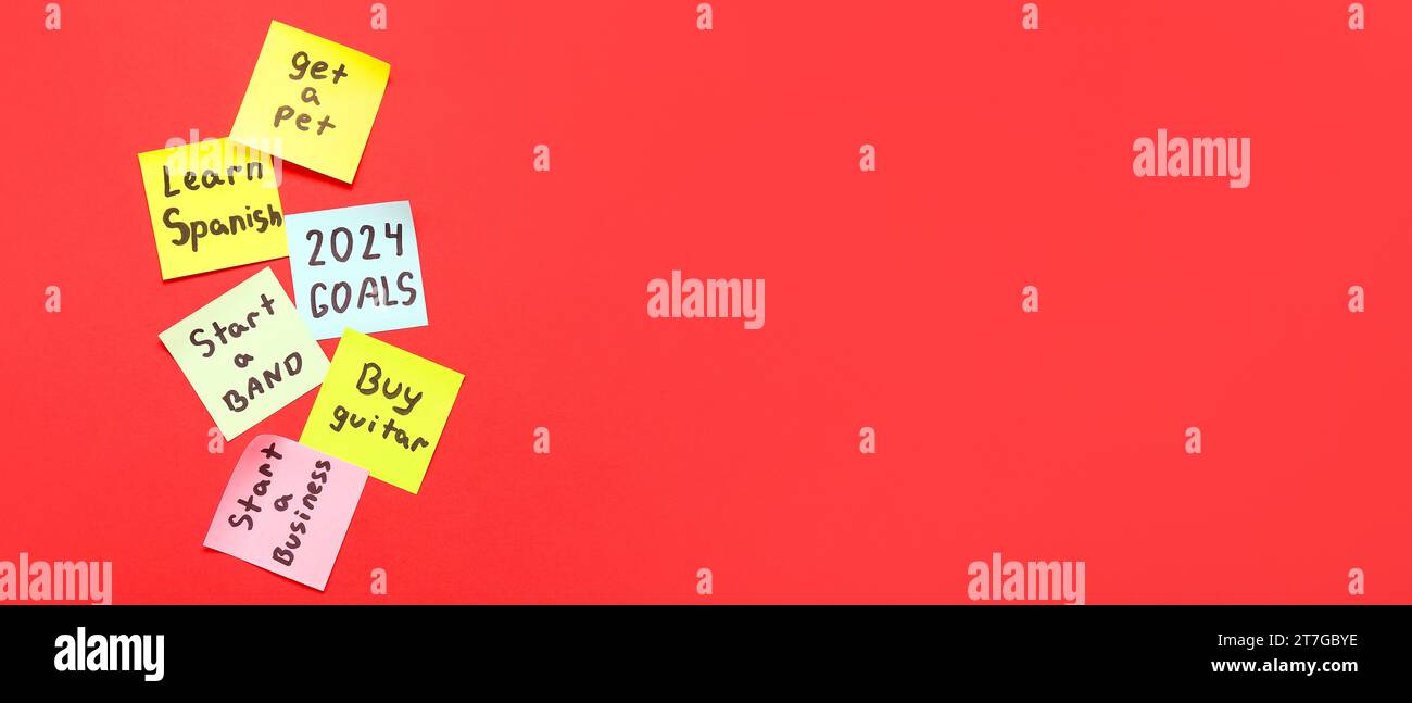 Sticky notes with different goals for 2024 on red background with space ...