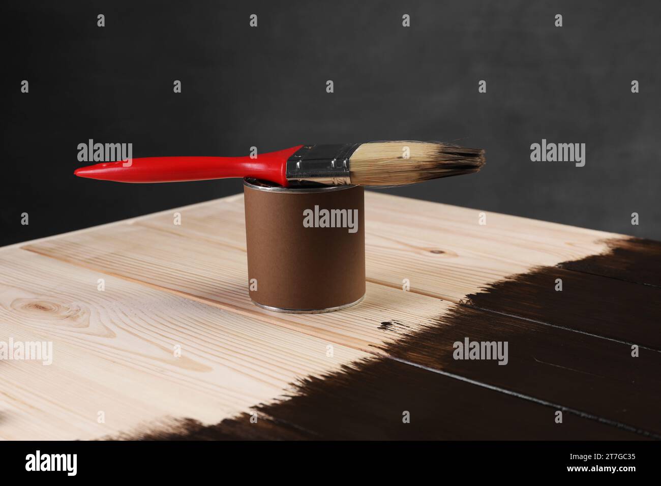 Brush and can of wood stain on wooden surface Stock Photo - Alamy