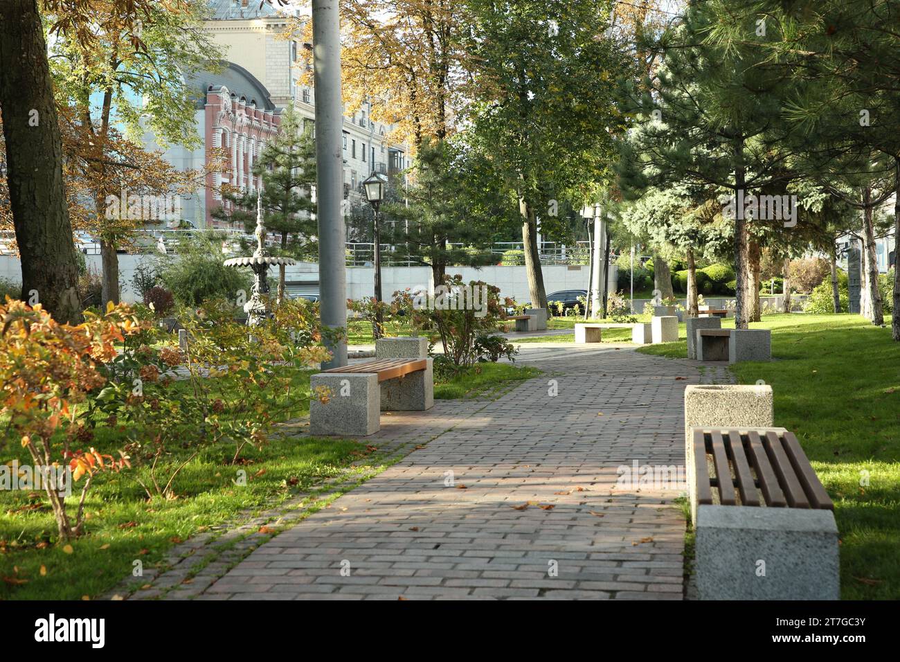 View of quiet city street with pathway on sunny day Stock Photo - Alamy