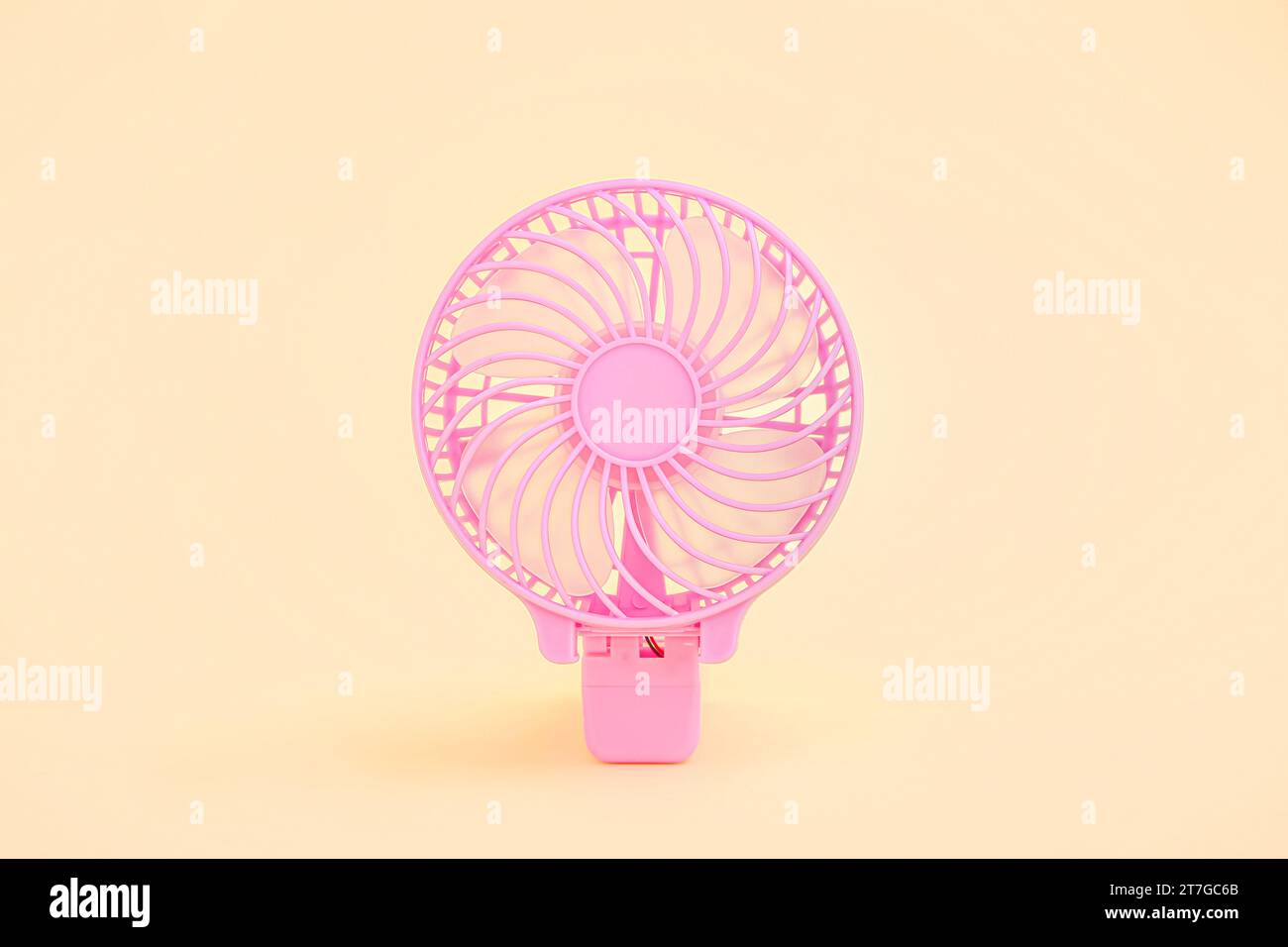 Mini pink electric fan on beige background Stock Photo - Alamy