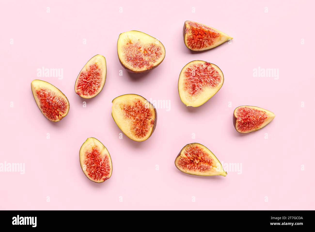 Cut fresh figs on pink background Stock Photo - Alamy