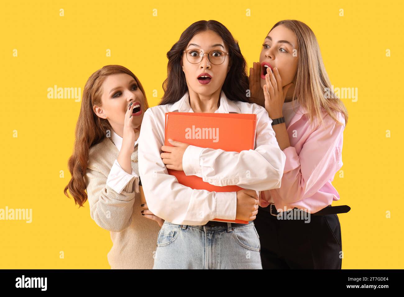 Business colleagues gossiping on yellow background Stock Photo - Alamy