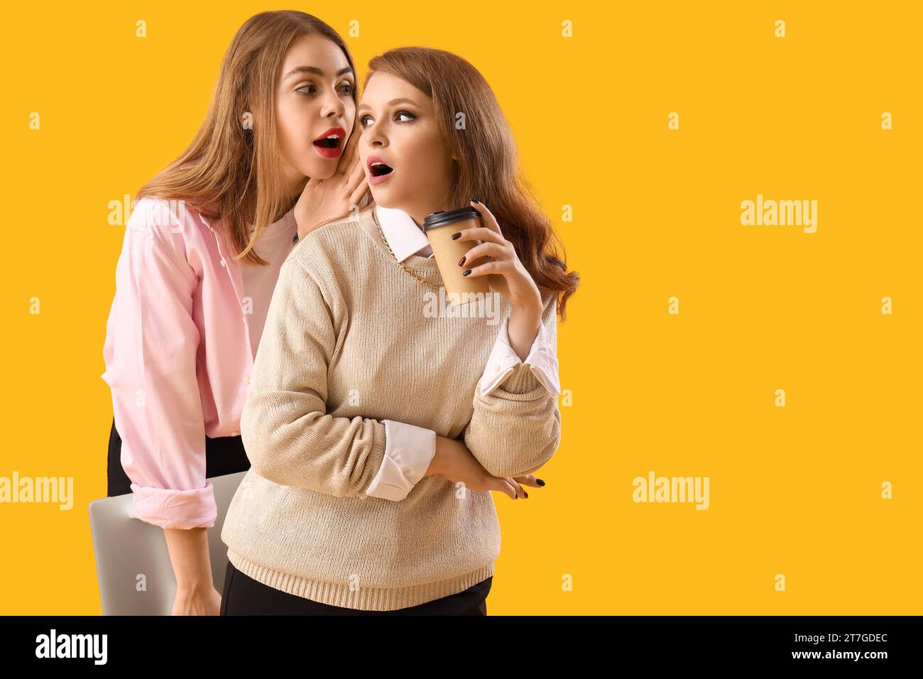 Business colleagues gossiping on yellow background Stock Photo - Alamy