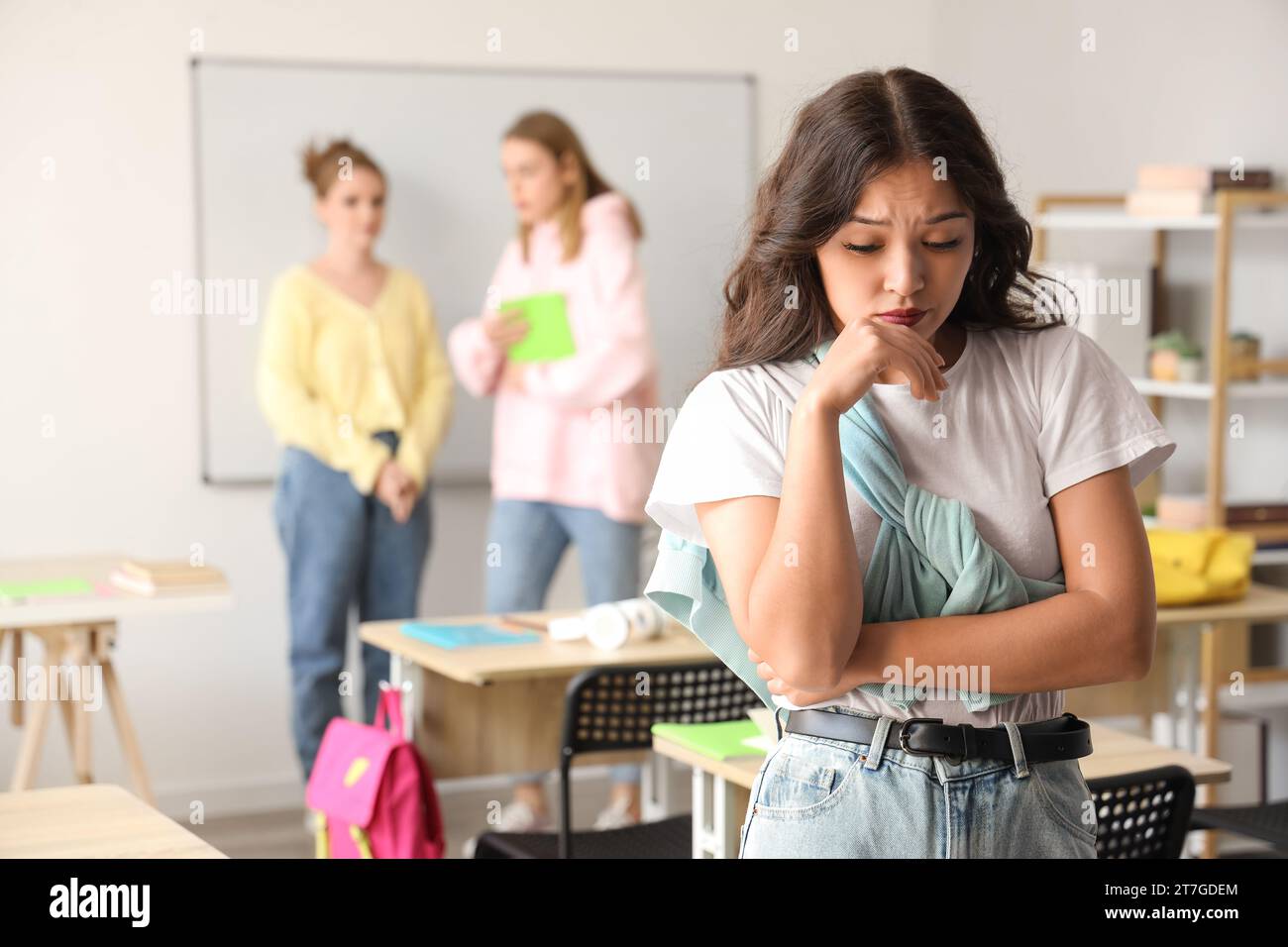 Female student upset of gossips in classroom Stock Photo - Alamy