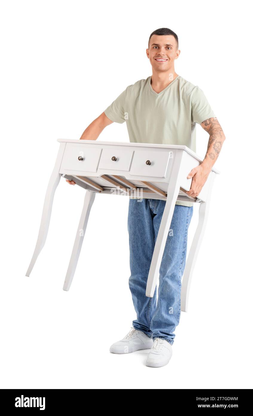 Young man carrying table on white background Stock Photo - Alamy