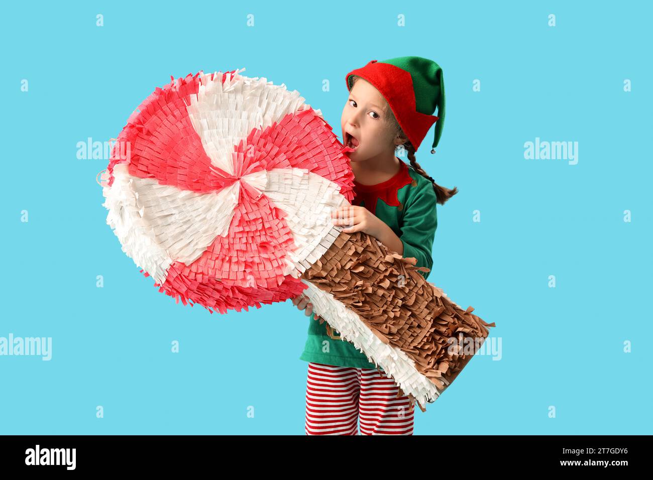 Cute little elf with candy pinata on blue background Stock Photo - Alamy
