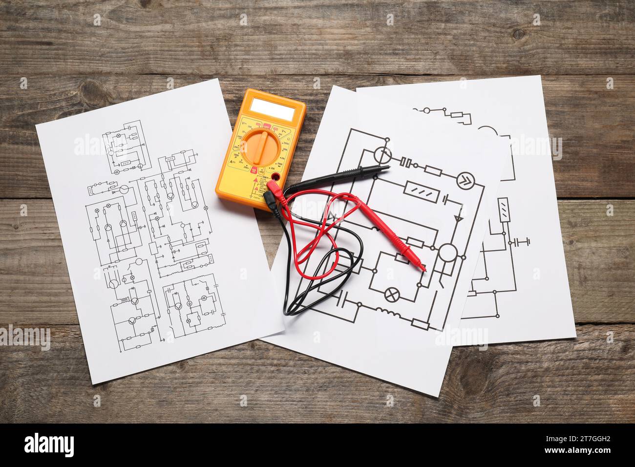Wiring diagrams and digital multimeter on wooden table, flat lay Stock ...