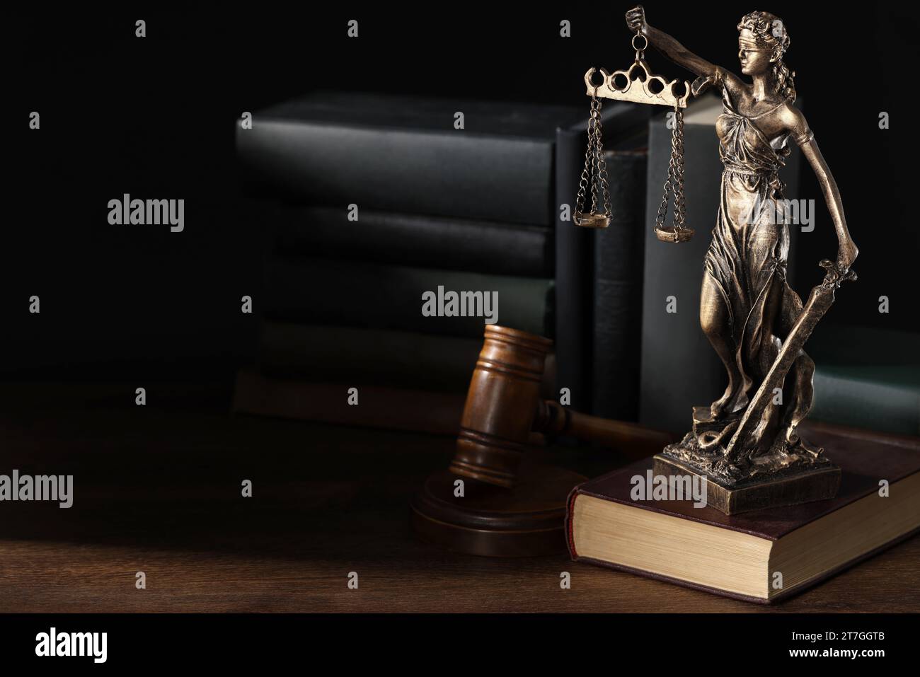 Symbol of fair treatment under law. Statue of Lady Justice near books ...