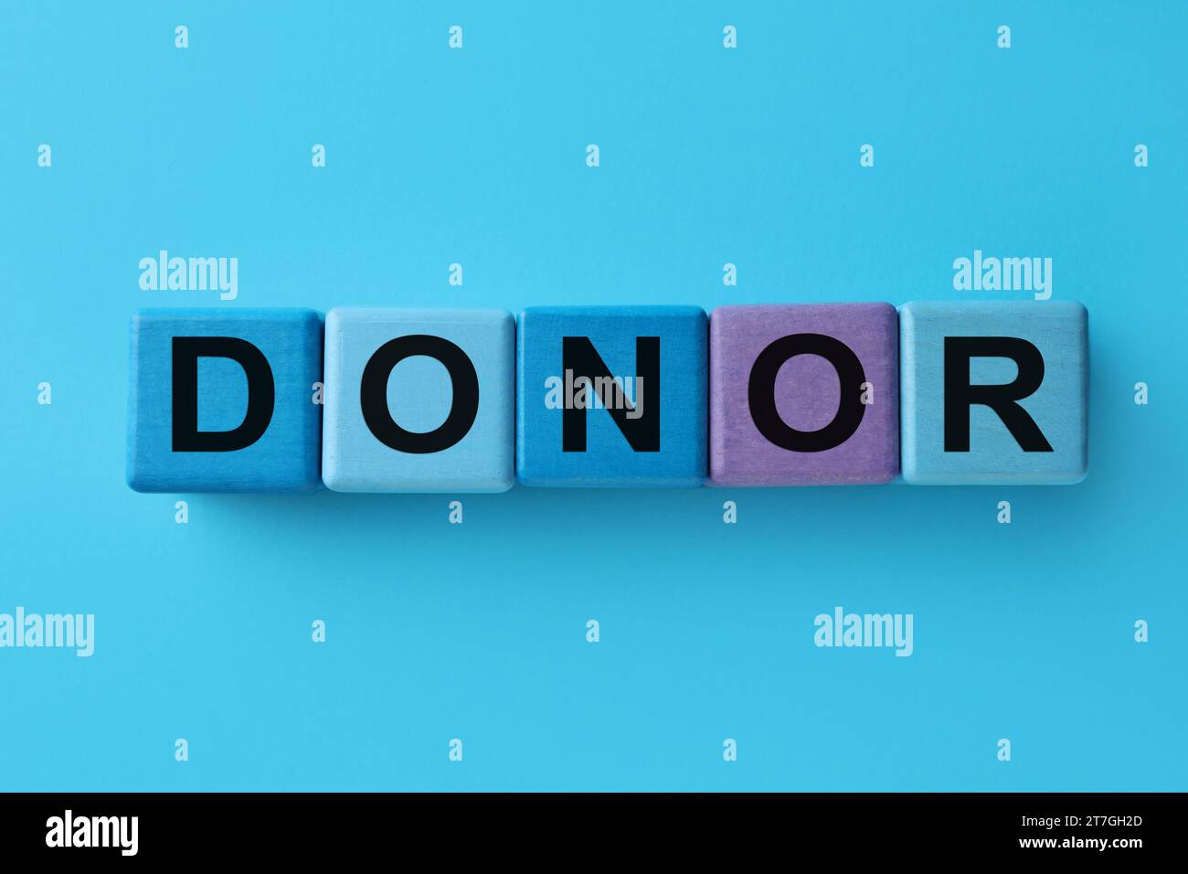 Word Donor made of cubes on light blue background, top view Stock Photo ...
