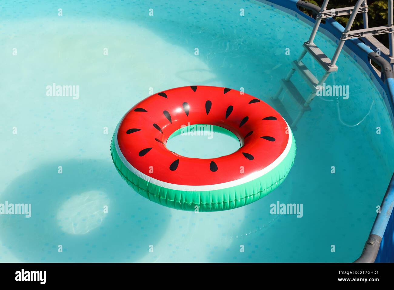 Inflatable ring floating on water in above ground swimming pool ...