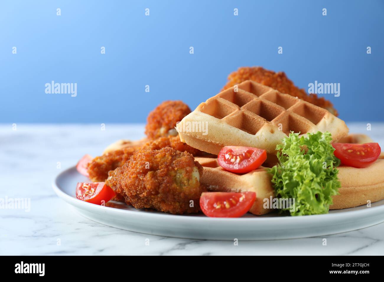 Tasty Belgian waffles served with fried chicken, tomatoes and lettuce ...