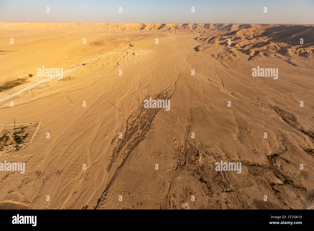 Aerial view of arid desert with braided dry river washes and eroded ...