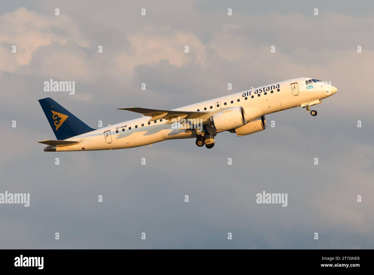 Air Astana Embraer 190 E2 aircraft taking off at Almaty Airport with mountains behind. New ...