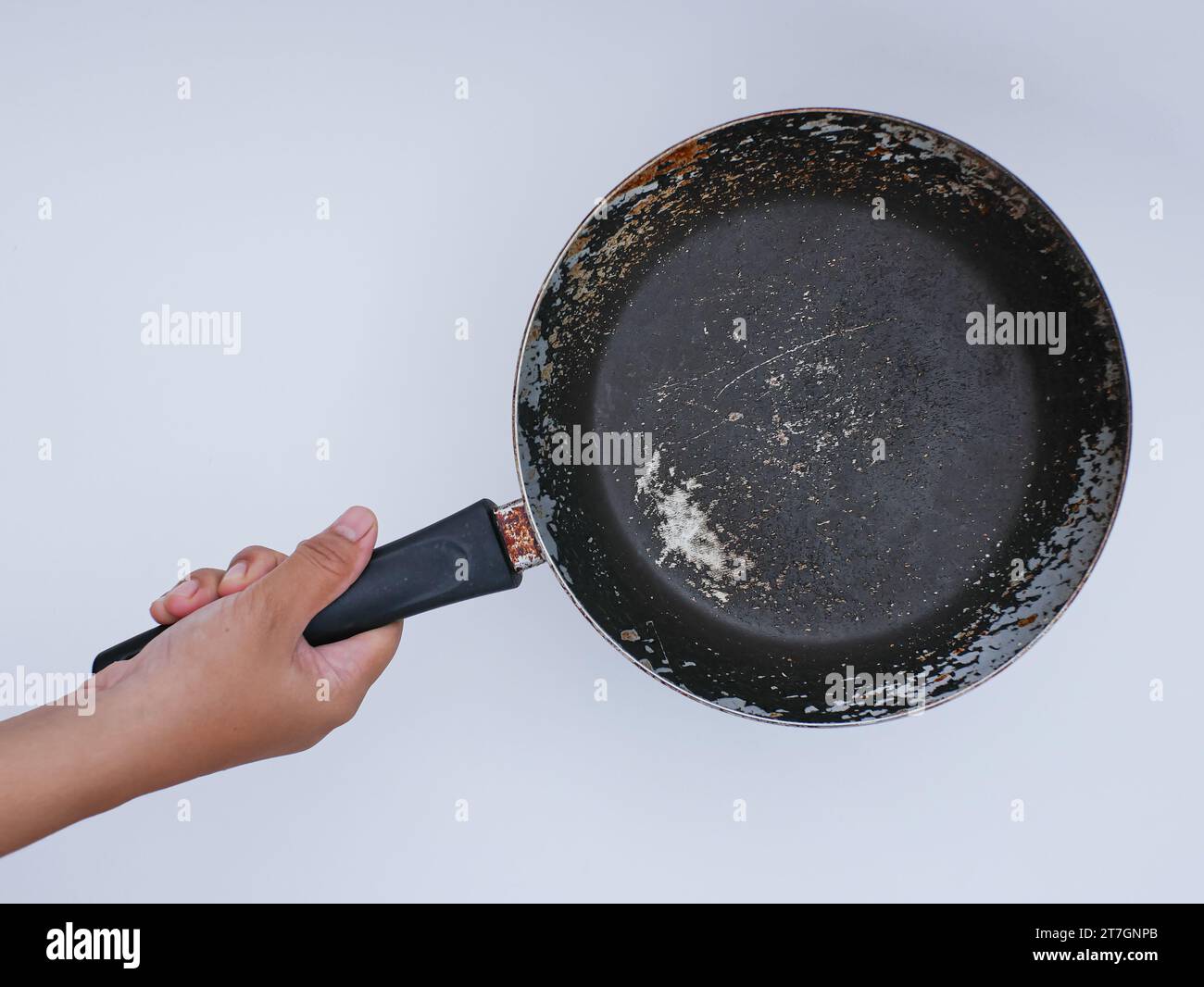 hand holding old used metal frying pan, isolated on white Stock Photo ...