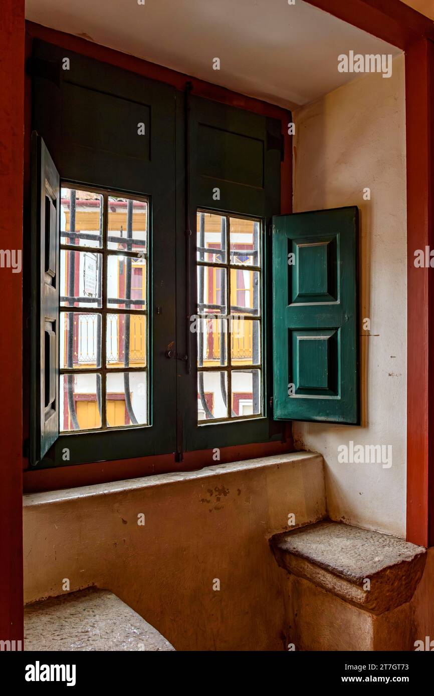 Old window inside a historic baroque church with a view of the colonial ...