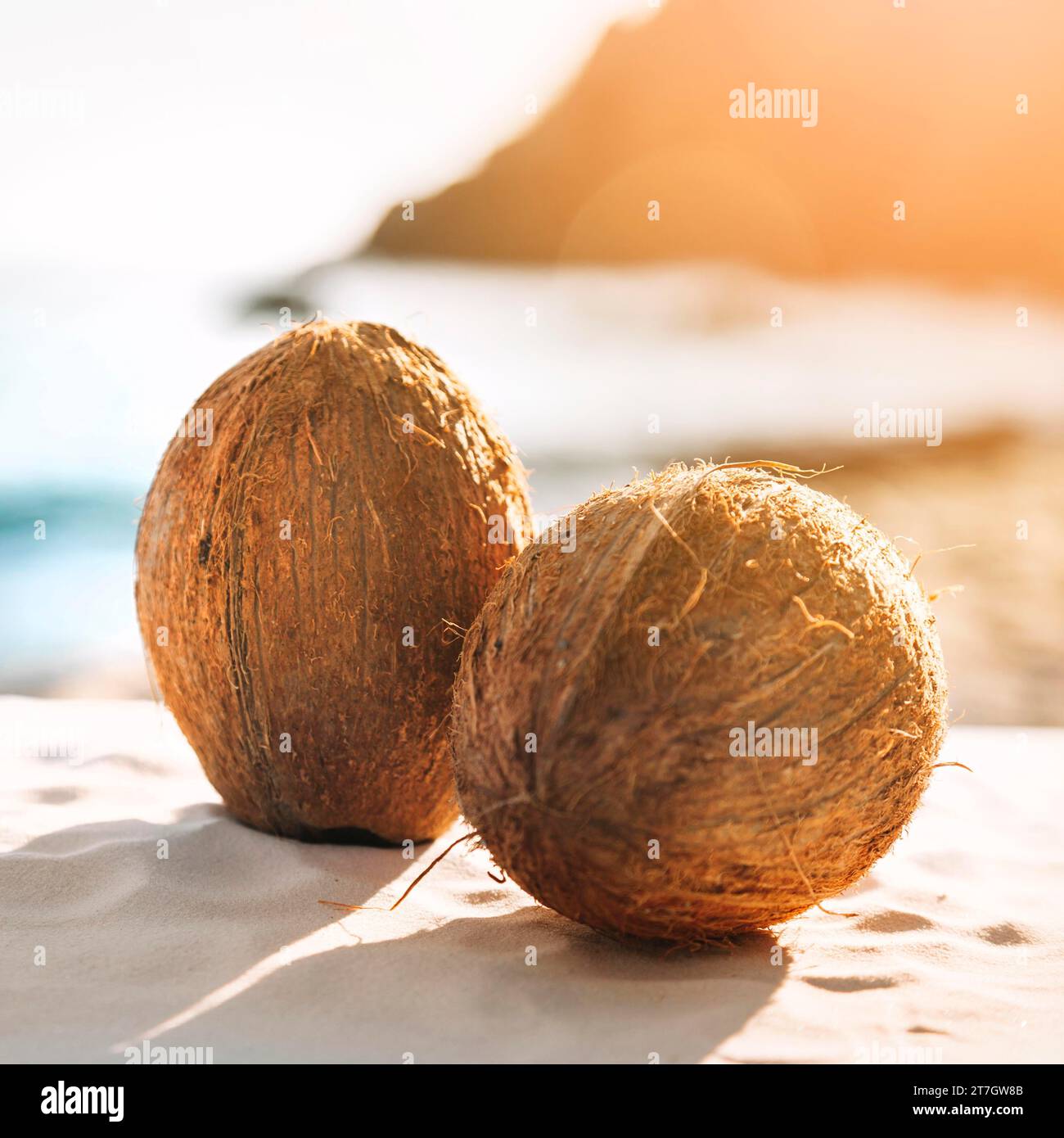Beach background with two coconuts Stock Photo - Alamy