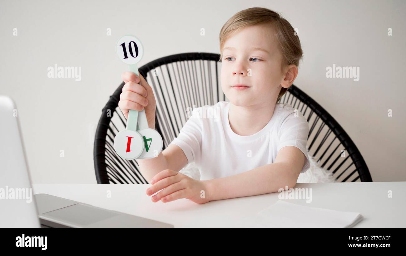 Child holding numbers mathematics online course Stock Photo - Alamy