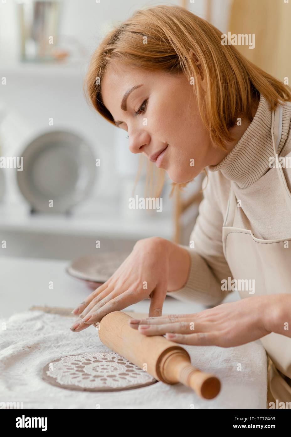 Close up woman using rolling pin pottery Stock Photo - Alamy