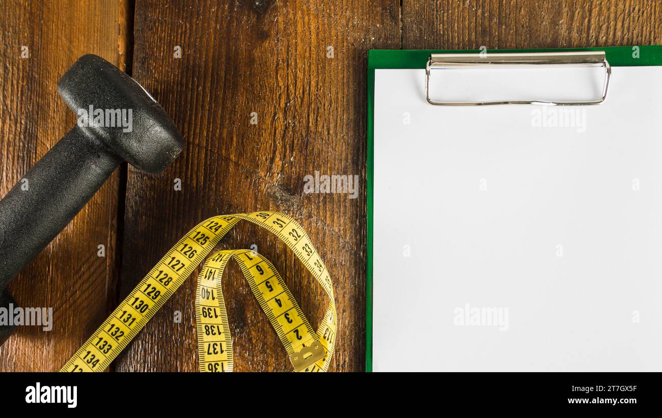 Elevated view dumbbell measuring tape blank paper with clipboard Stock ...