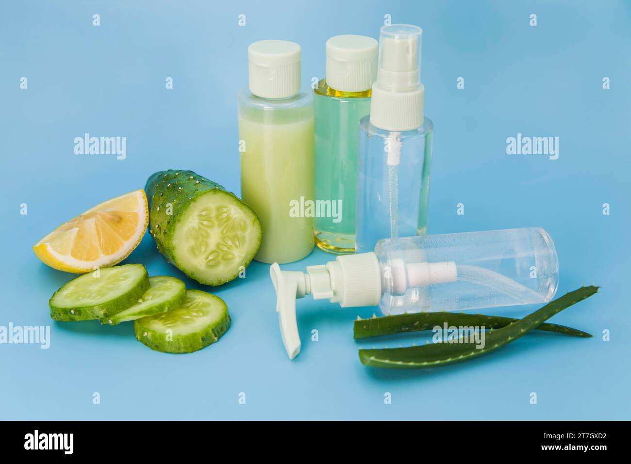 Fresh aloe vera lemon cucumber slices spray bottles blue background ...