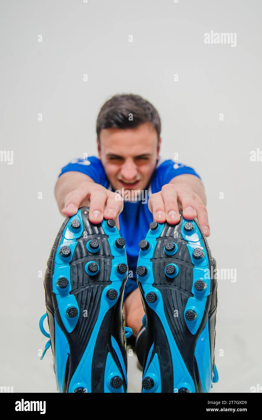 Football player stretching Stock Photo - Alamy