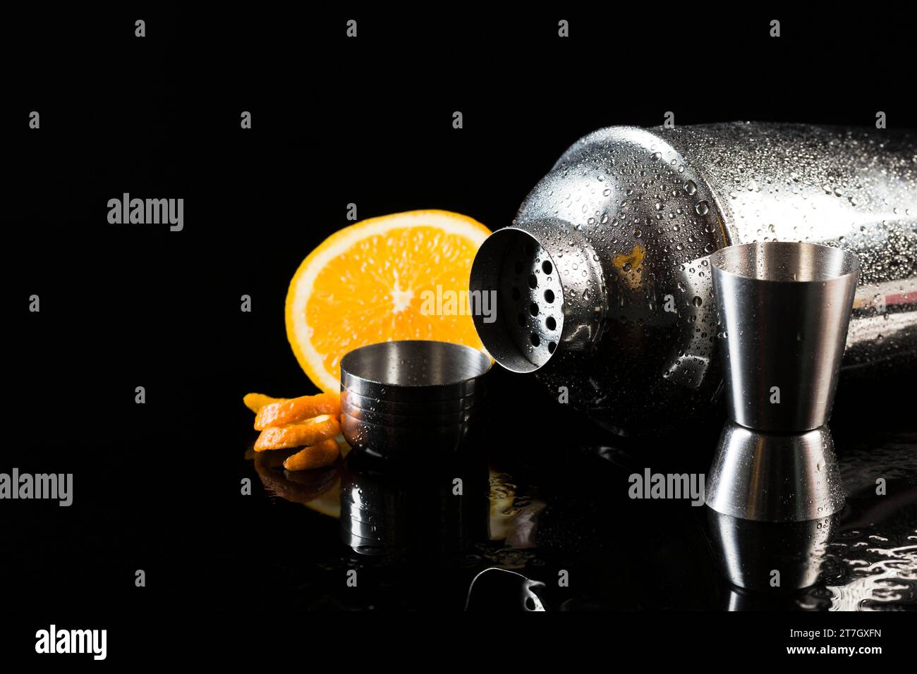 Front view cocktail shaker with orange shot glass Stock Photo - Alamy