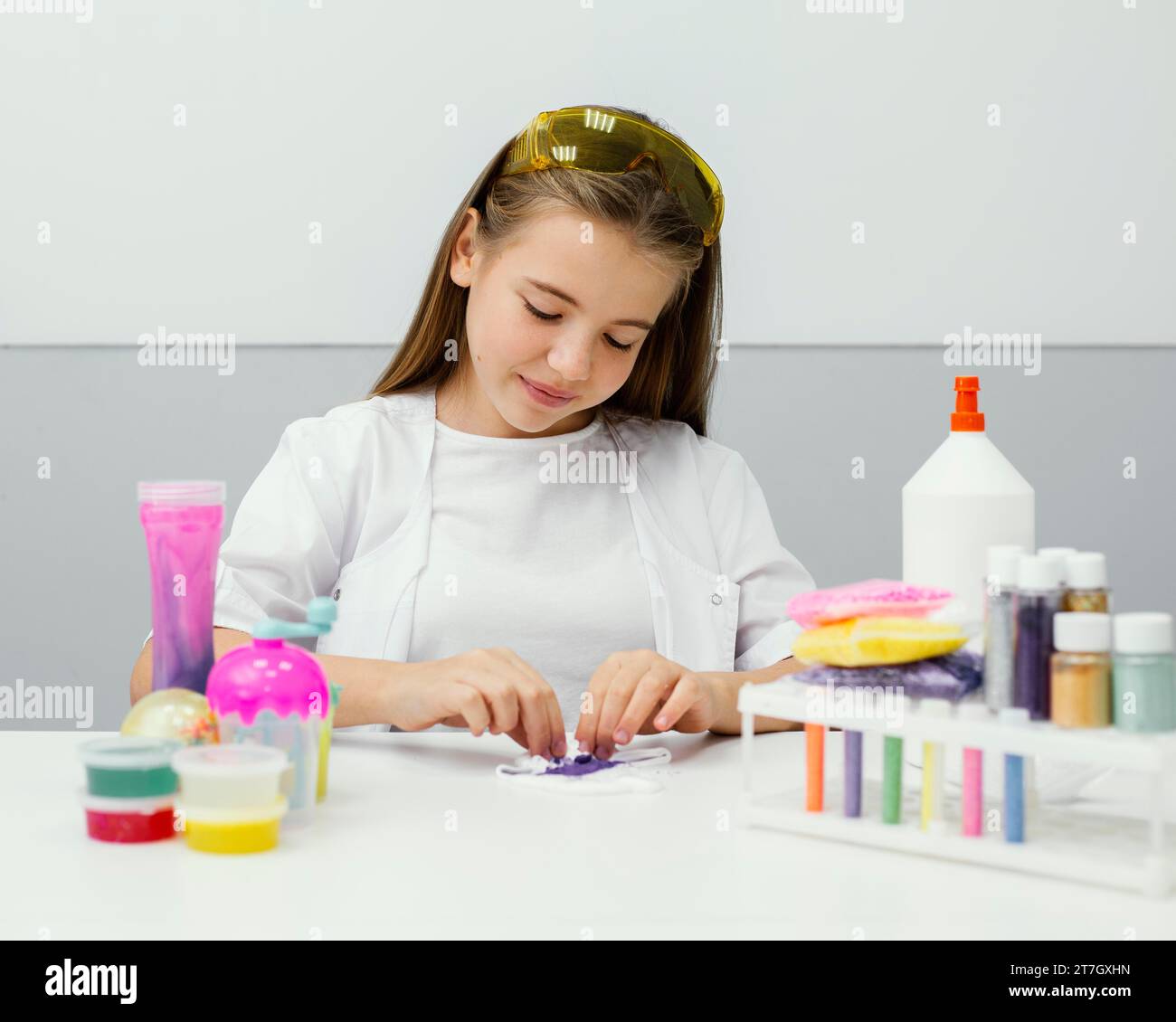 Front view young girl scientist making slime Stock Photo - Alamy
