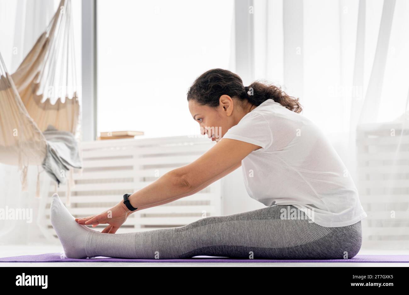 Full shot woman stretching 2 Stock Photo - Alamy