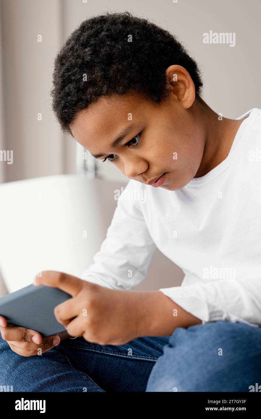 Little boy playing mobile Stock Photo - Alamy
