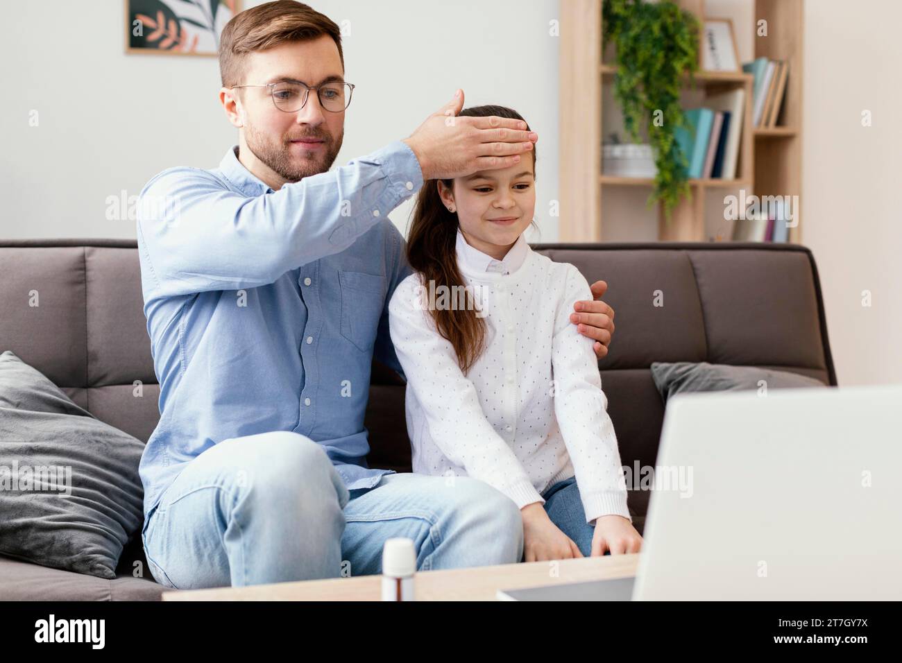Medium shot man checking girl temperature Stock Photo - Alamy Medium shot man checking girl temperature Stock Photo - Alamy