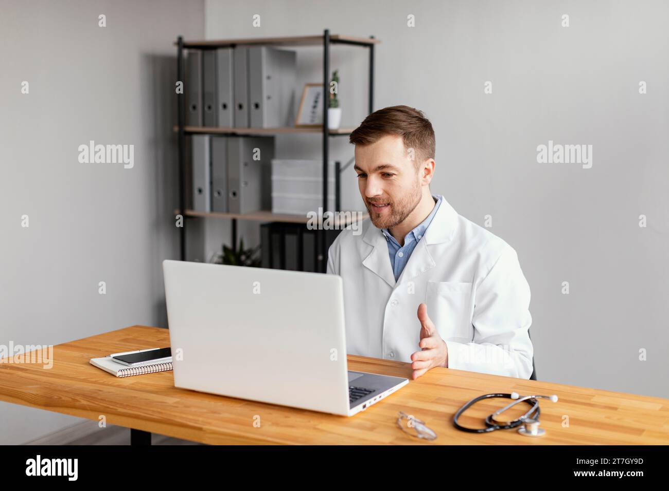 Medium shot doctor working desk 3 Stock Photo - Alamy