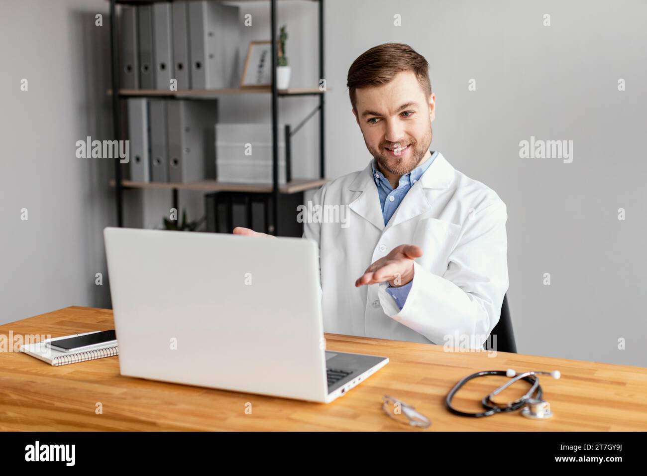 Medium shot doctor working desk Stock Photo - Alamy