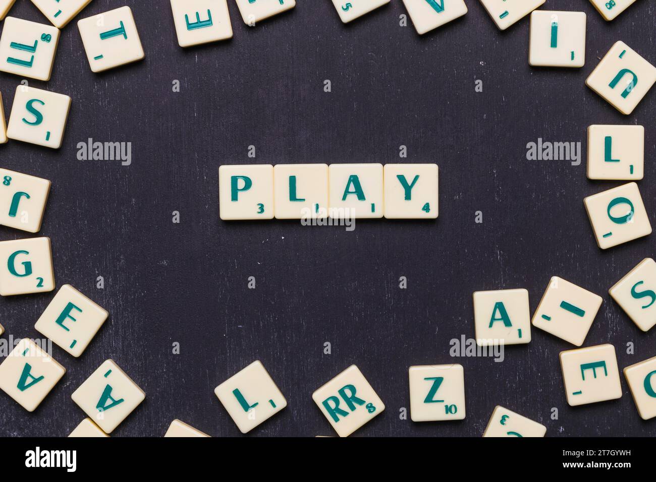 Play scrabble letters black background Stock Photo - Alamy
