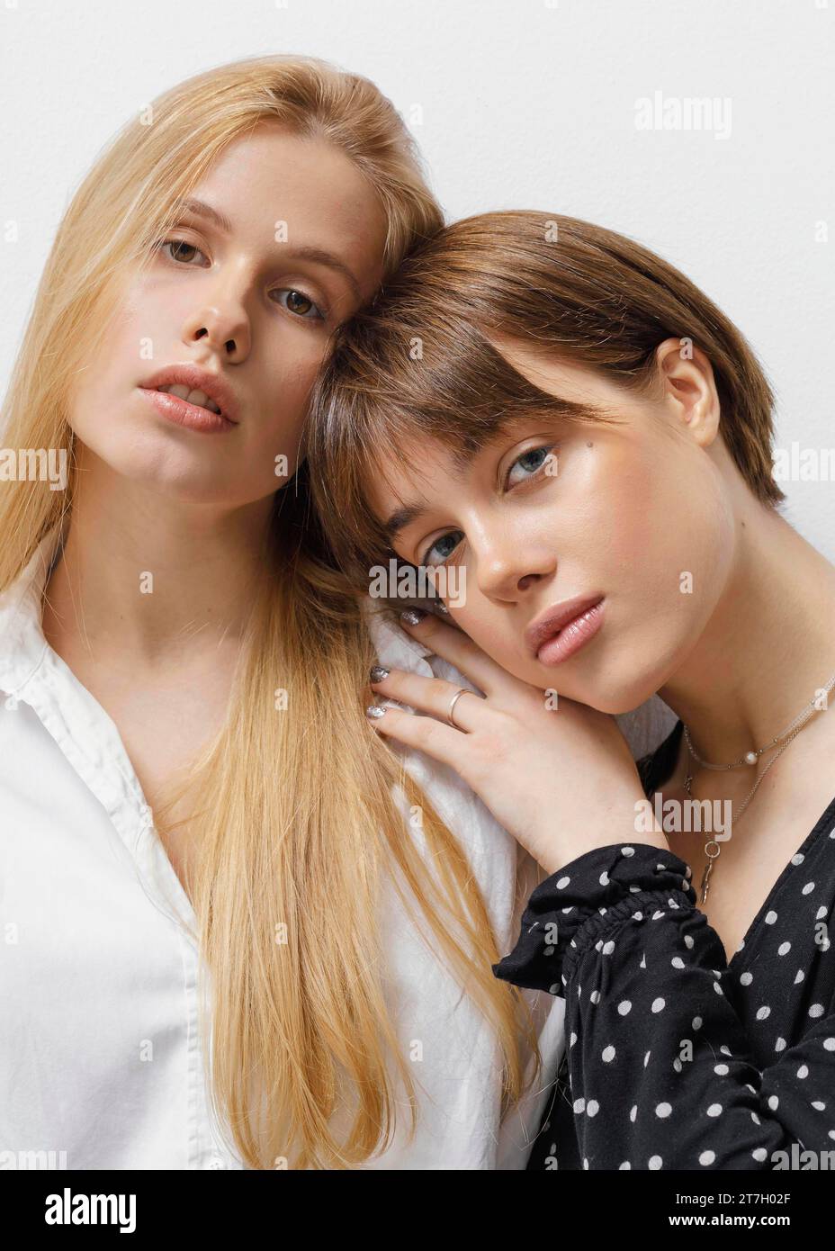 Portrait beautiful young females posing Stock Photo - Alamy